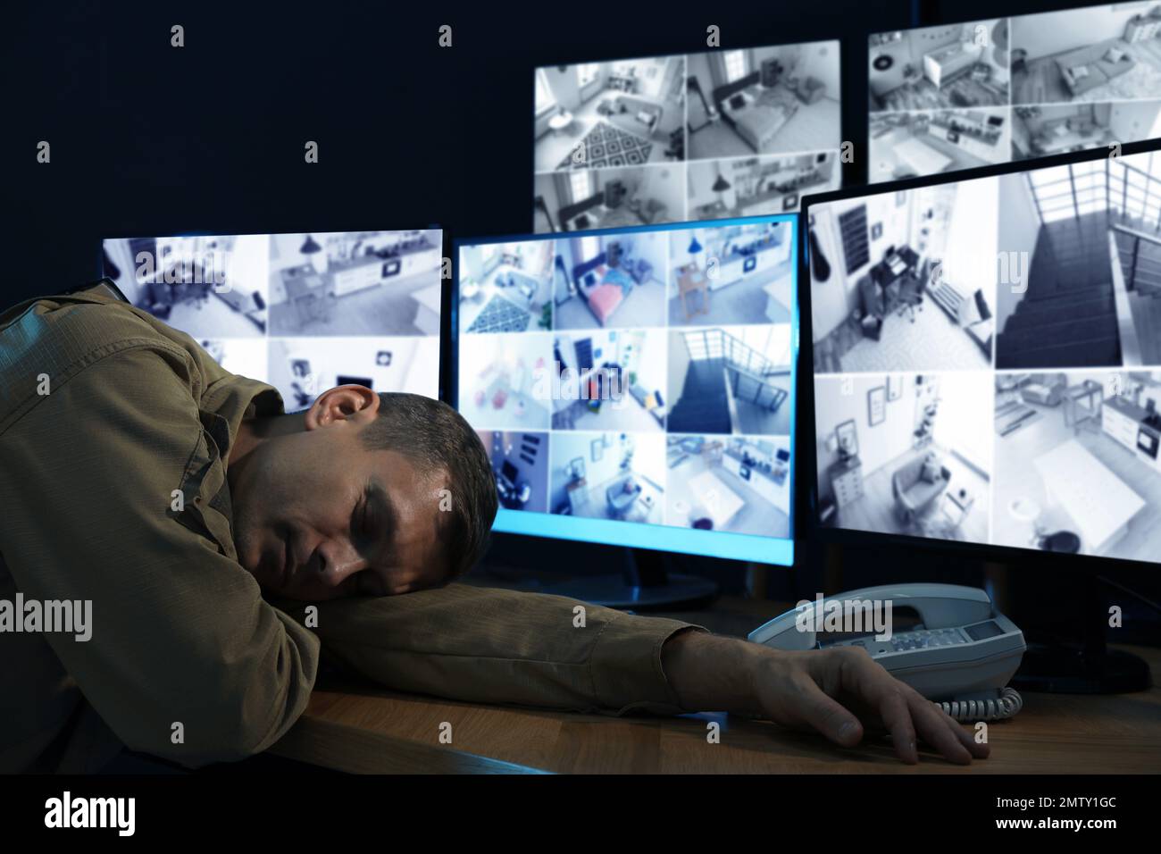 Tired security guard sleeping in office at night Stock Photo - Alamy
