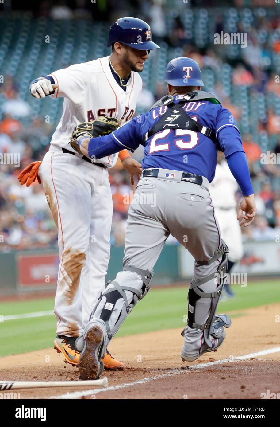 Houston Astros' Yuli Gurriel, left, is tagged out by Texas Rangers ...