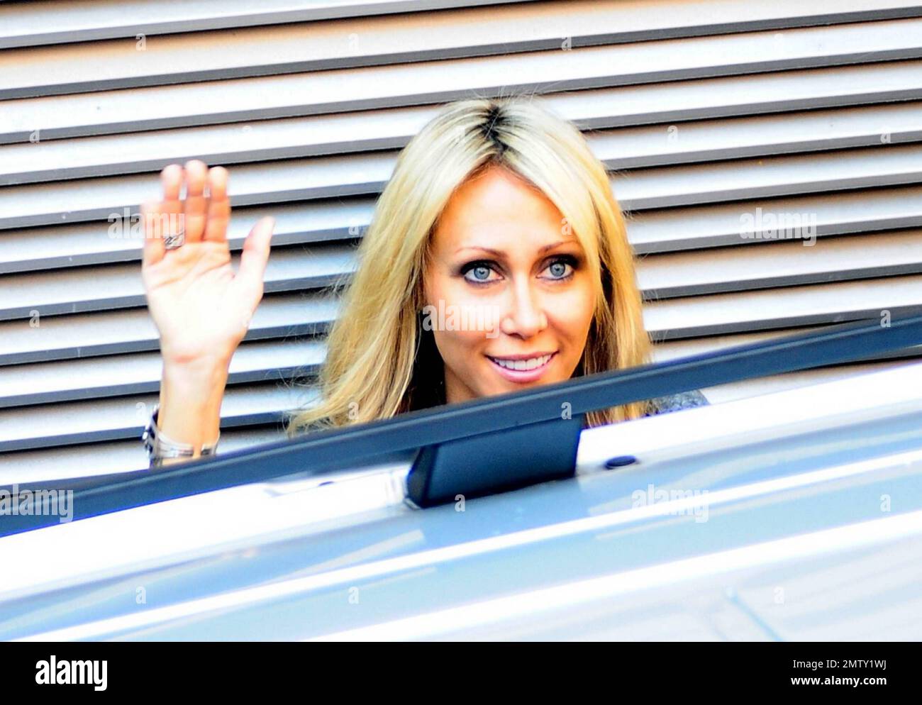 Miley Cyrus' mom Tish Cyrus waves to fans and photographers as she ...