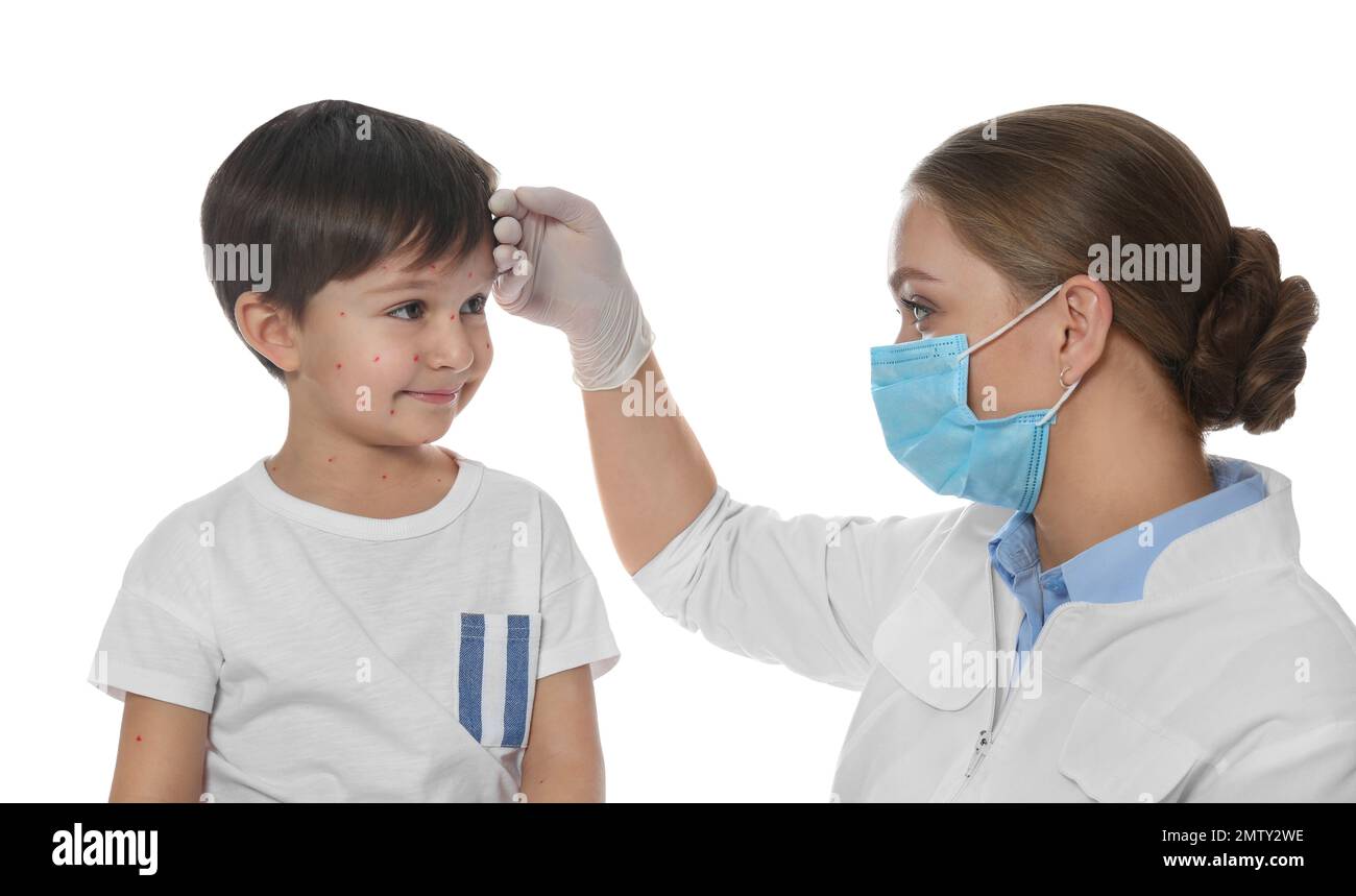 Doctor examining little boy with chickenpox on white background ...