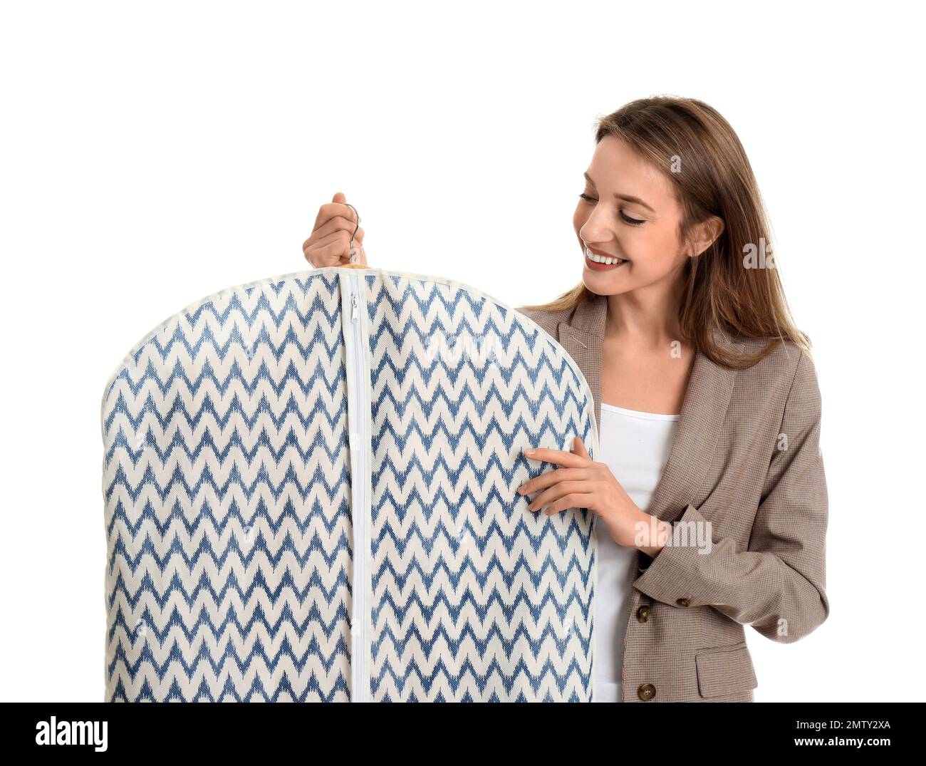 Young woman holding garment cover with clothes on white background. Dry ...