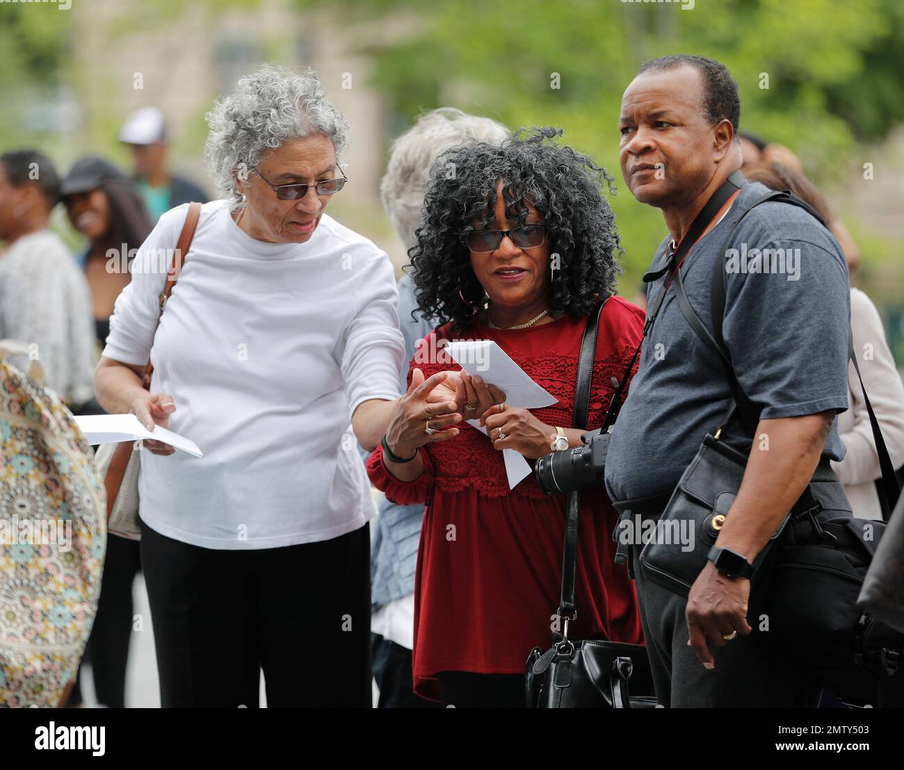 Lucille Simpson, left, hands out tickets to her daughter Gwendolyn ...