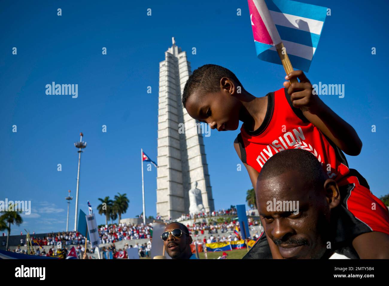 People march carrying Cuban flags during the May Day parade at ...