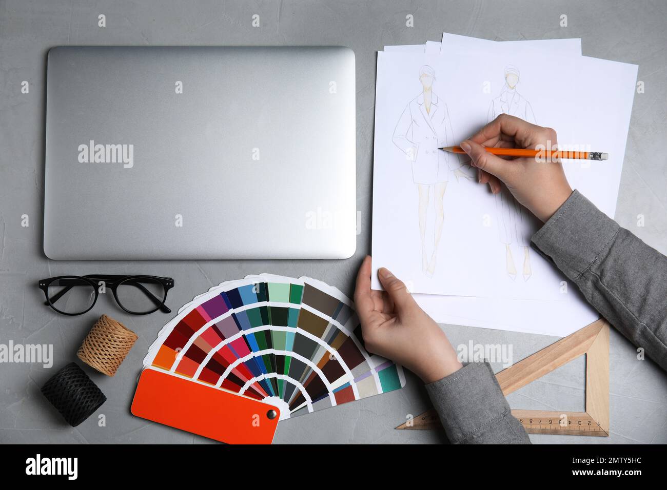 Designer drawing sketch at grey stone table, top view Stock Photo - Alamy