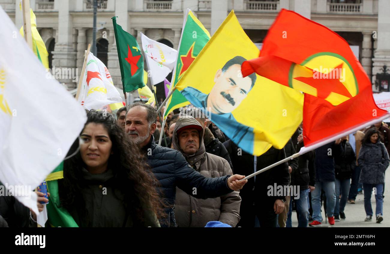 Kurds carry a flag with a portrait of former PKK leader Abdullah Ocalan ...
