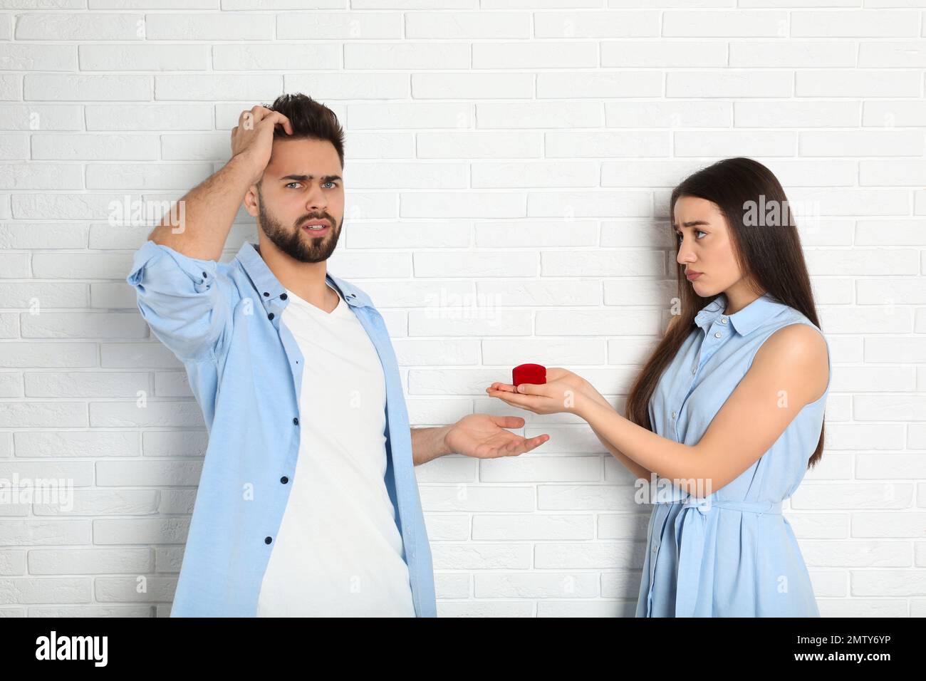 Young Woman With Engagement Ring Making Marriage Proposal To Her