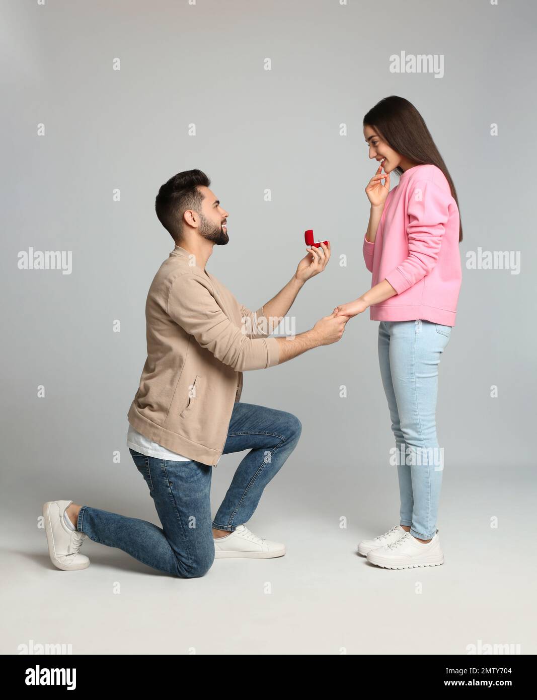 Man with engagement ring making marriage proposal to girlfriend on ...