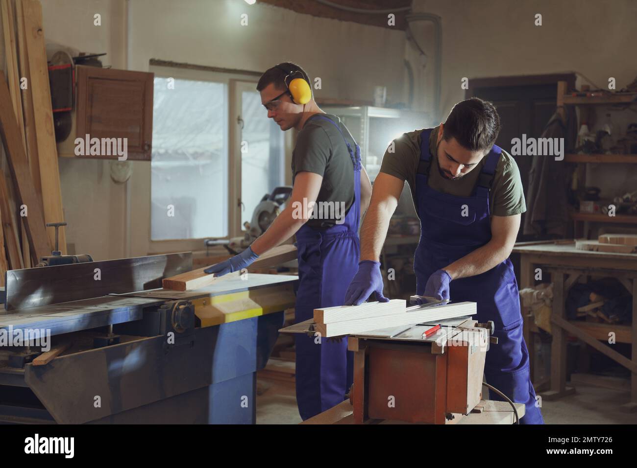 Professional carpenters working with wood in shop Stock Photo - Alamy