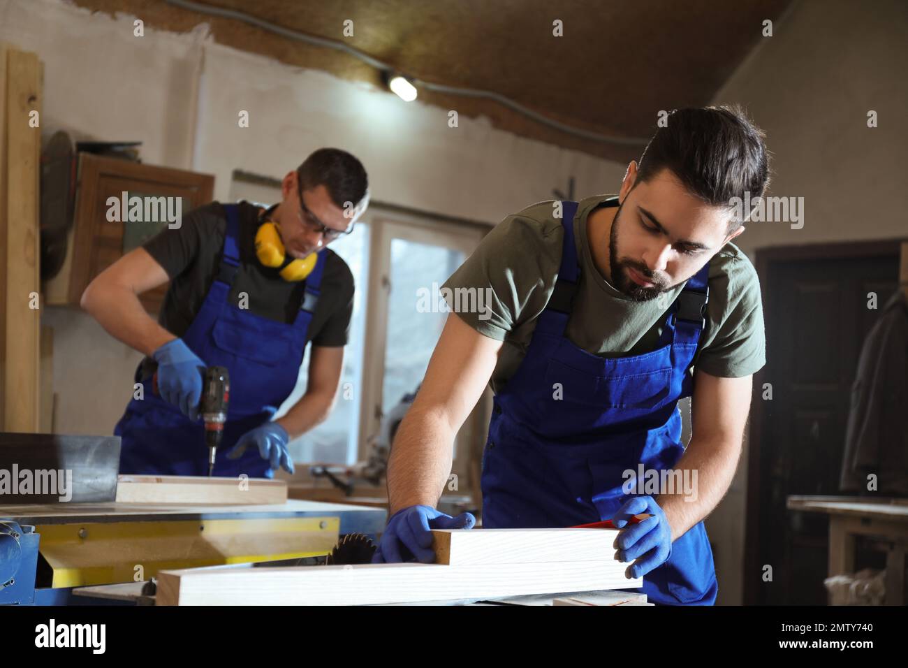 Professional carpenters working with wood in shop Stock Photo - Alamy