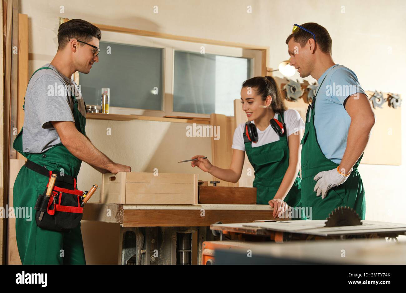 Professional carpenters with wooden crate in workshop Stock Photo - Alamy