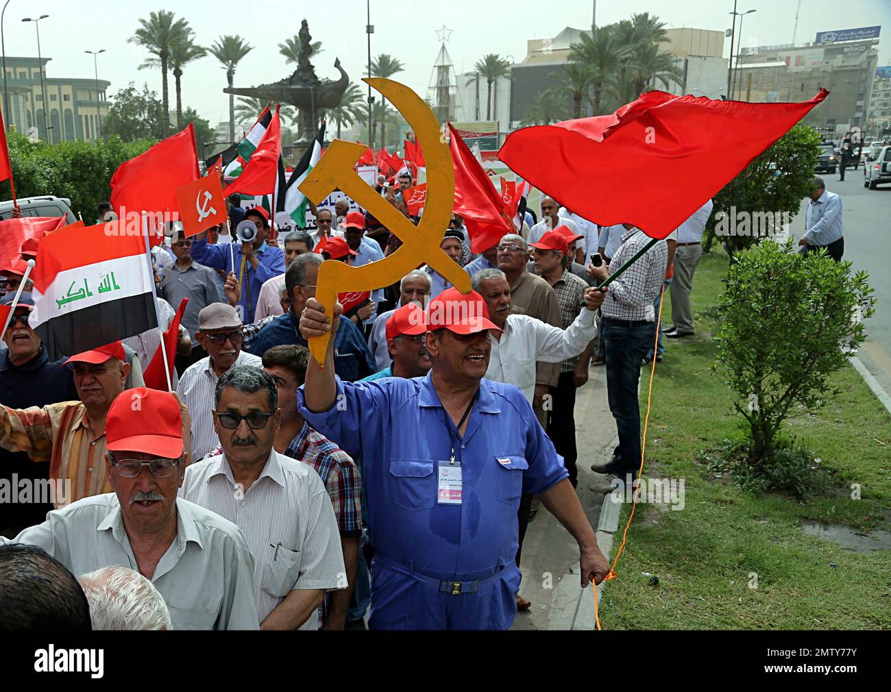 Supporters of the Iraqi Communist Party wave communist and national ...