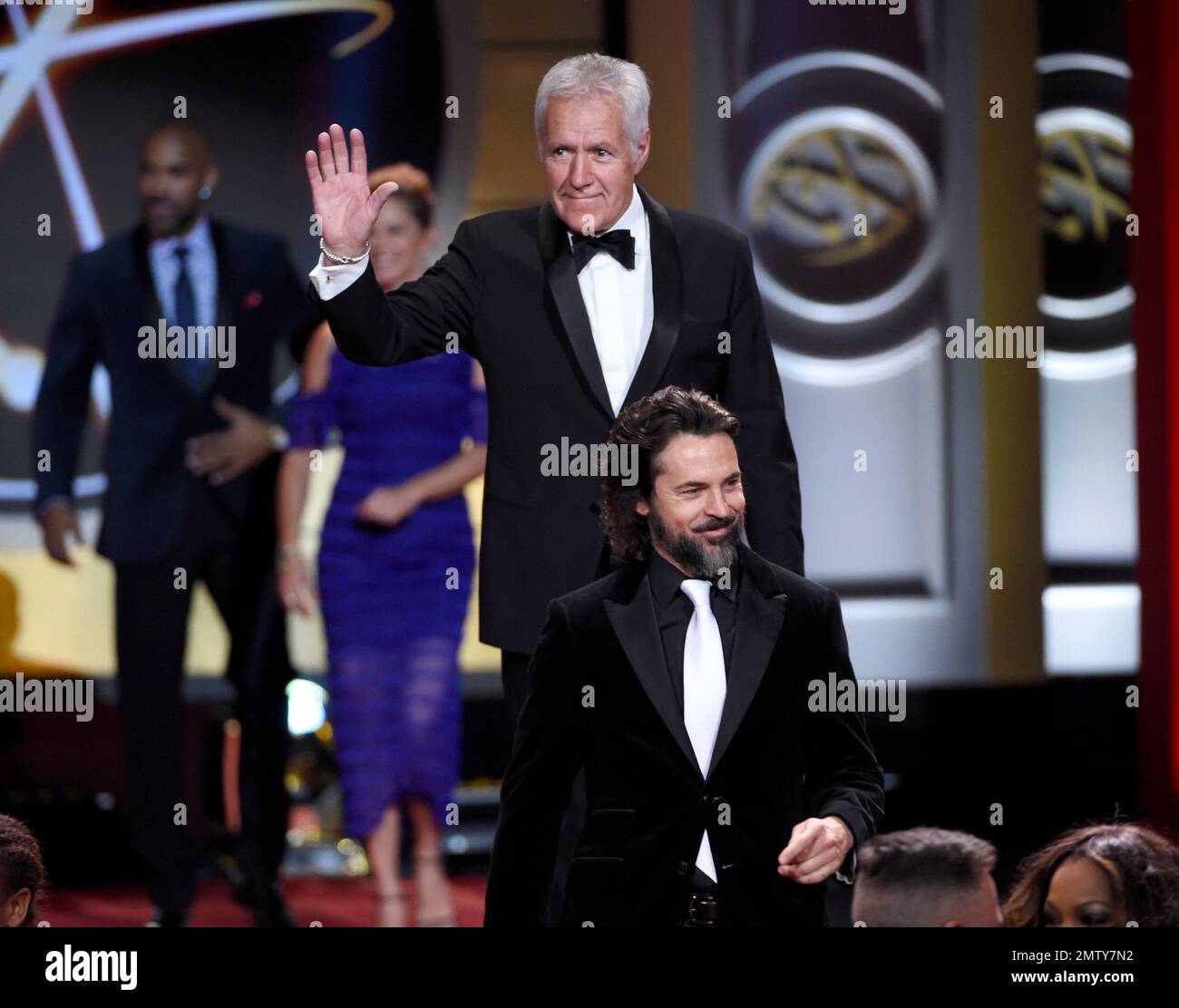 Alex Trebek, in back, and Jeffrey Vincent Parise walk out on stage at ...