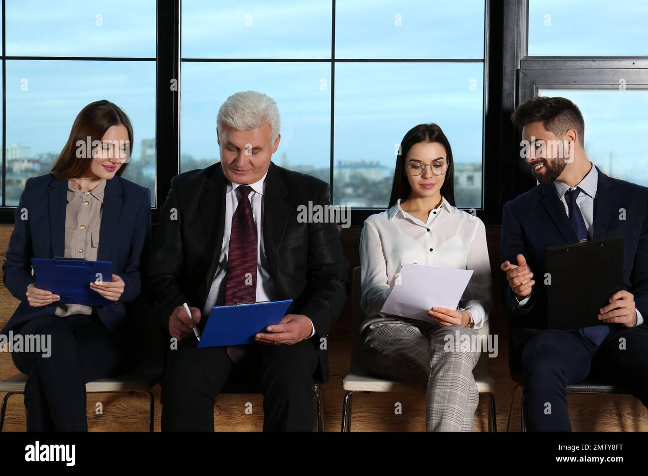 People waiting for job interview in office hall Stock Photo - Alamy