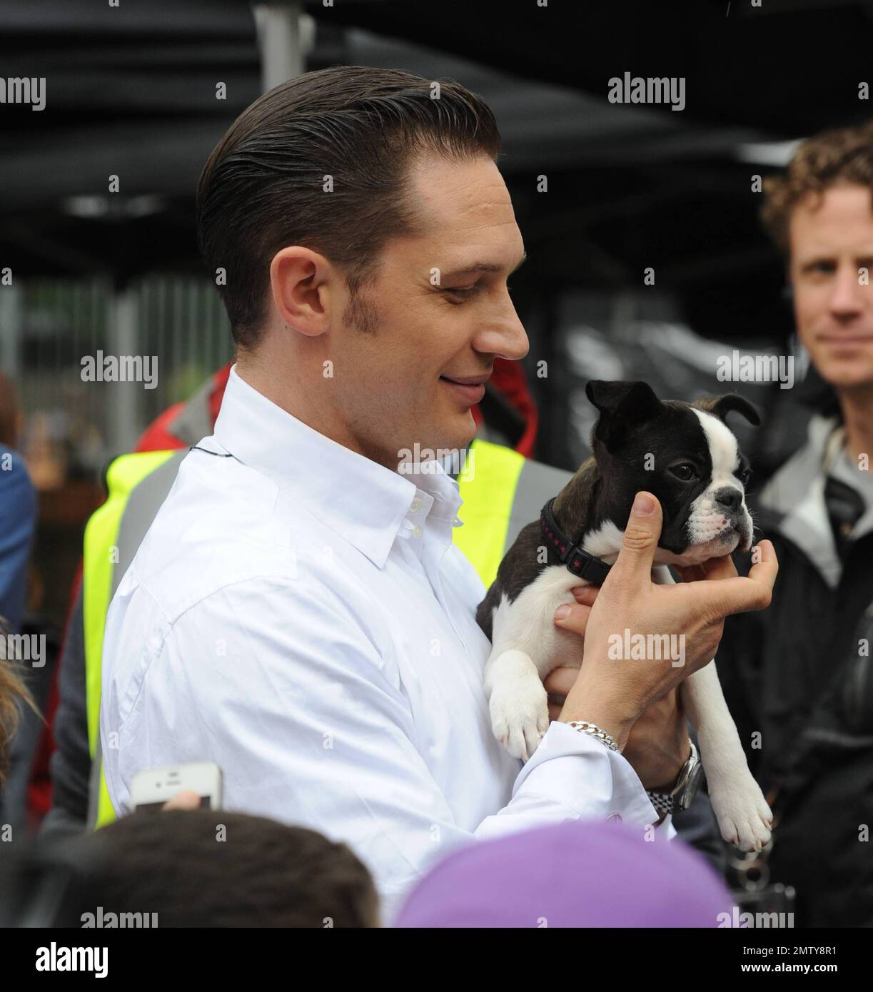 Tom Hardy receives a dog licking while on set of the new Krays movie ...