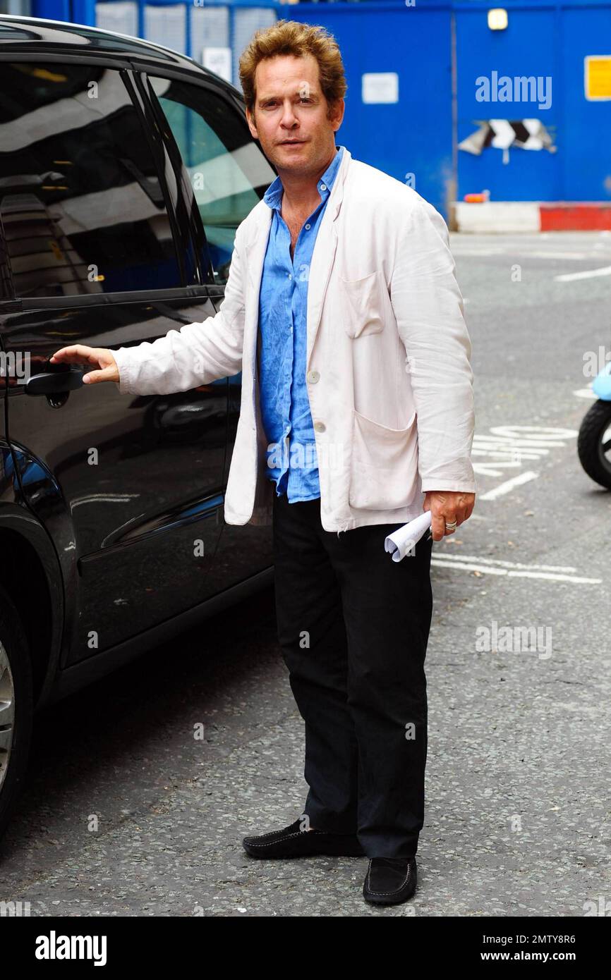 Actor Tom Hollander poses for photos as he leaves the BBC studios ...