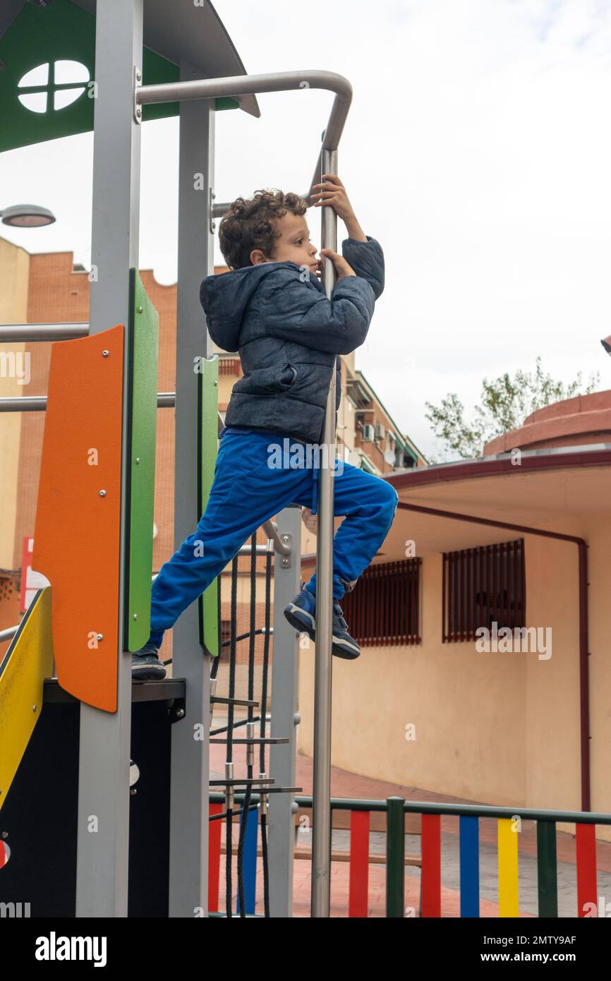 Child playing climbing pole hi-res stock photography and images - Alamy