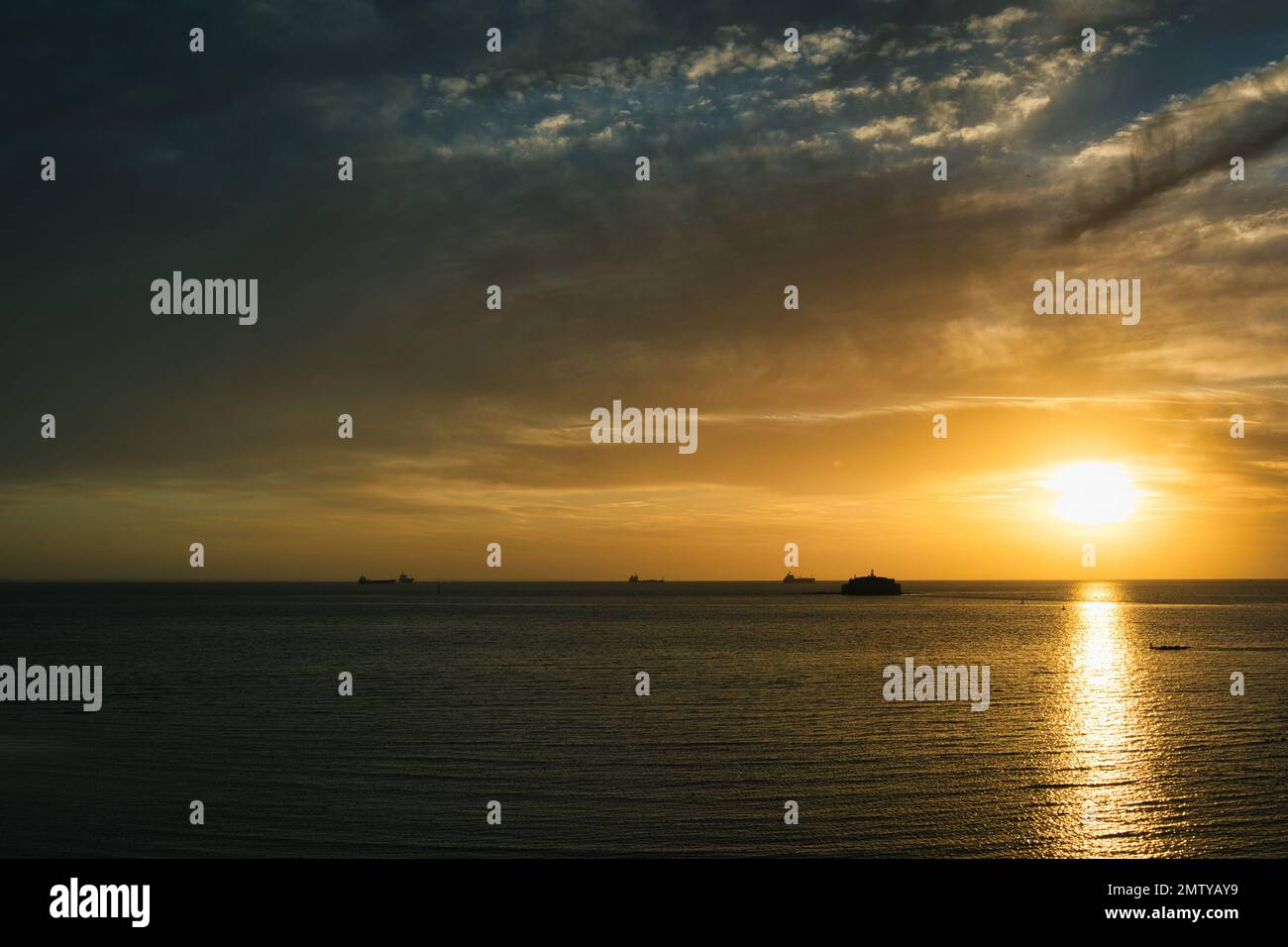 A mesmerizing view of the golden sunset over the sea Stock Photo - Alamy