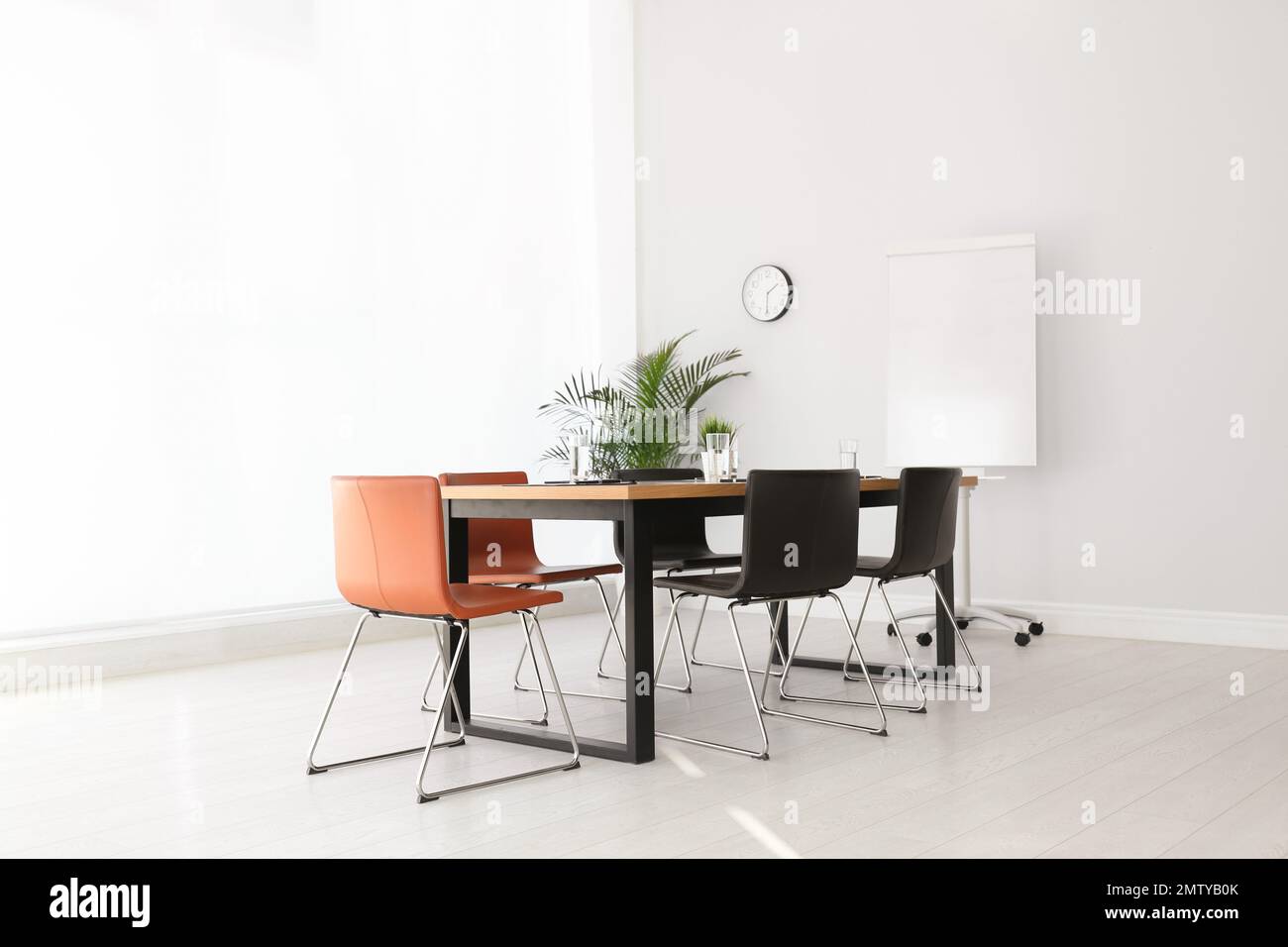 Simple office interior with large table and chairs Stock Photo - Alamy