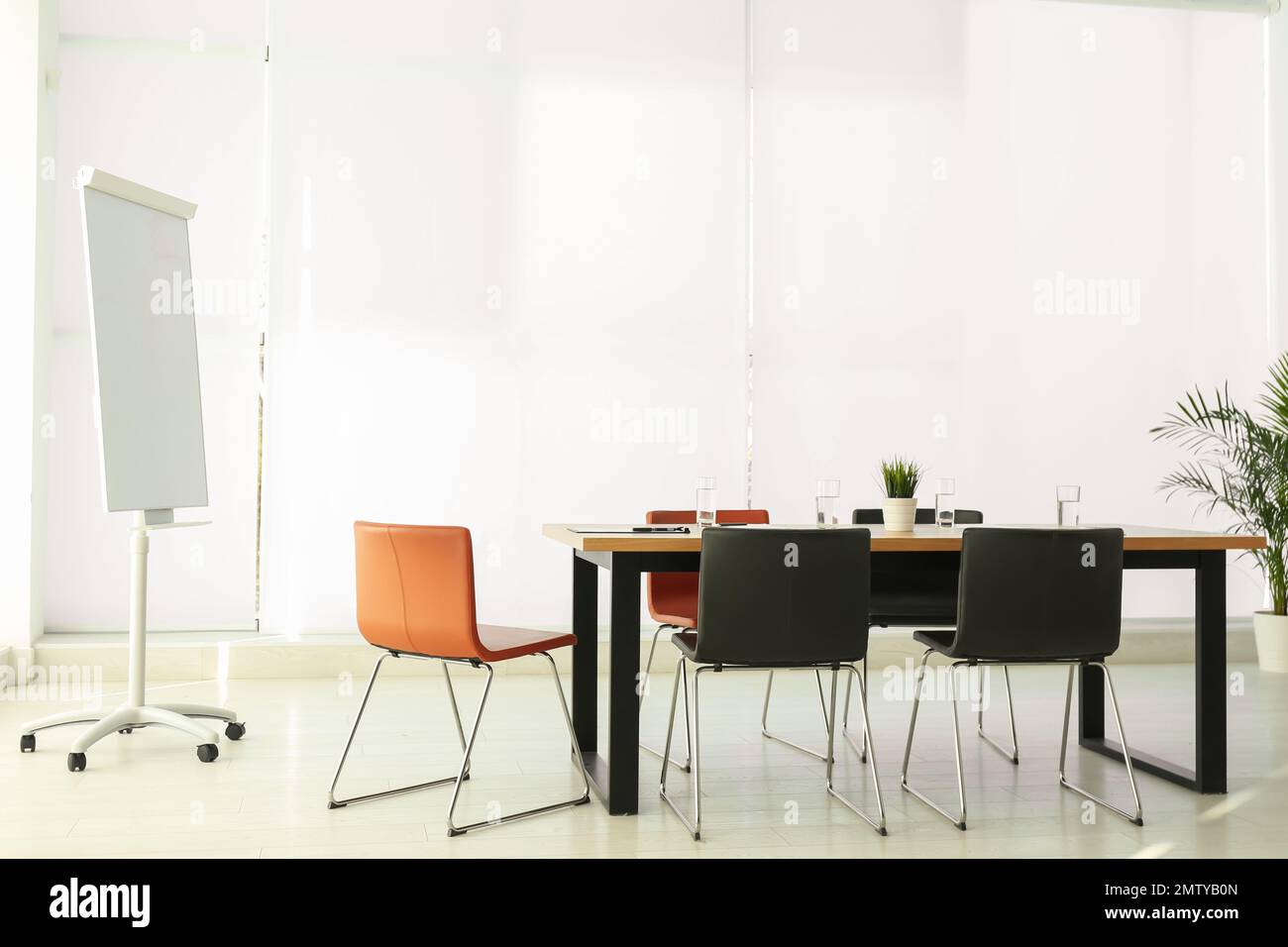 Simple office interior with large table and chairs Stock Photo - Alamy