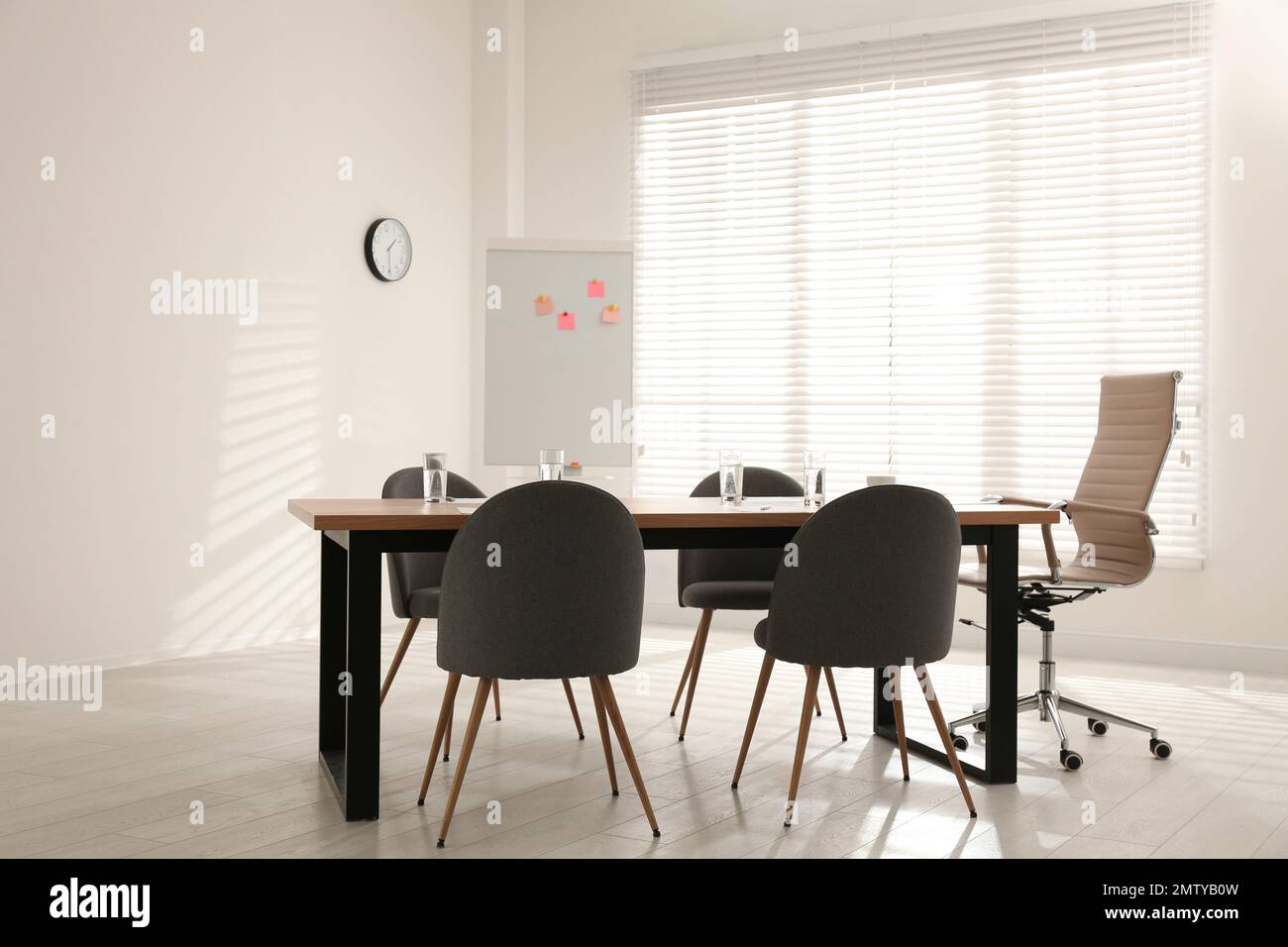 Simple office interior with large table and chairs Stock Photo - Alamy