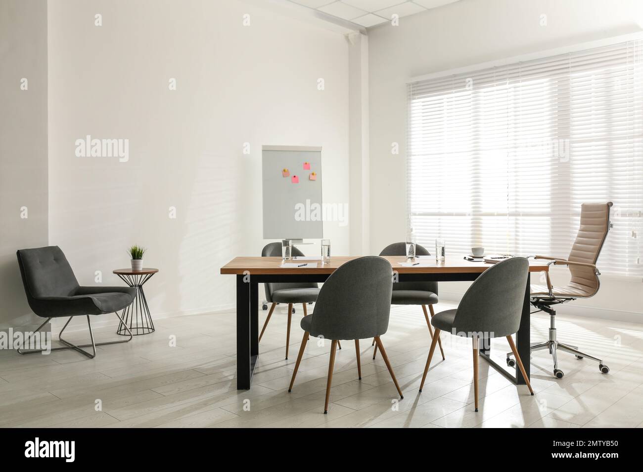 Simple office interior with large table and chairs Stock Photo - Alamy