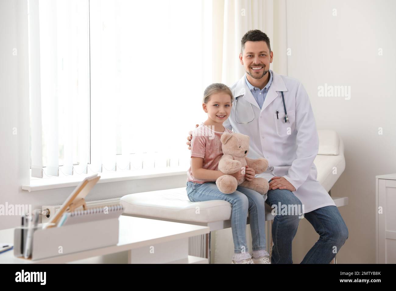 Children's doctor working with little patient in clinic Stock Photo - Alamy