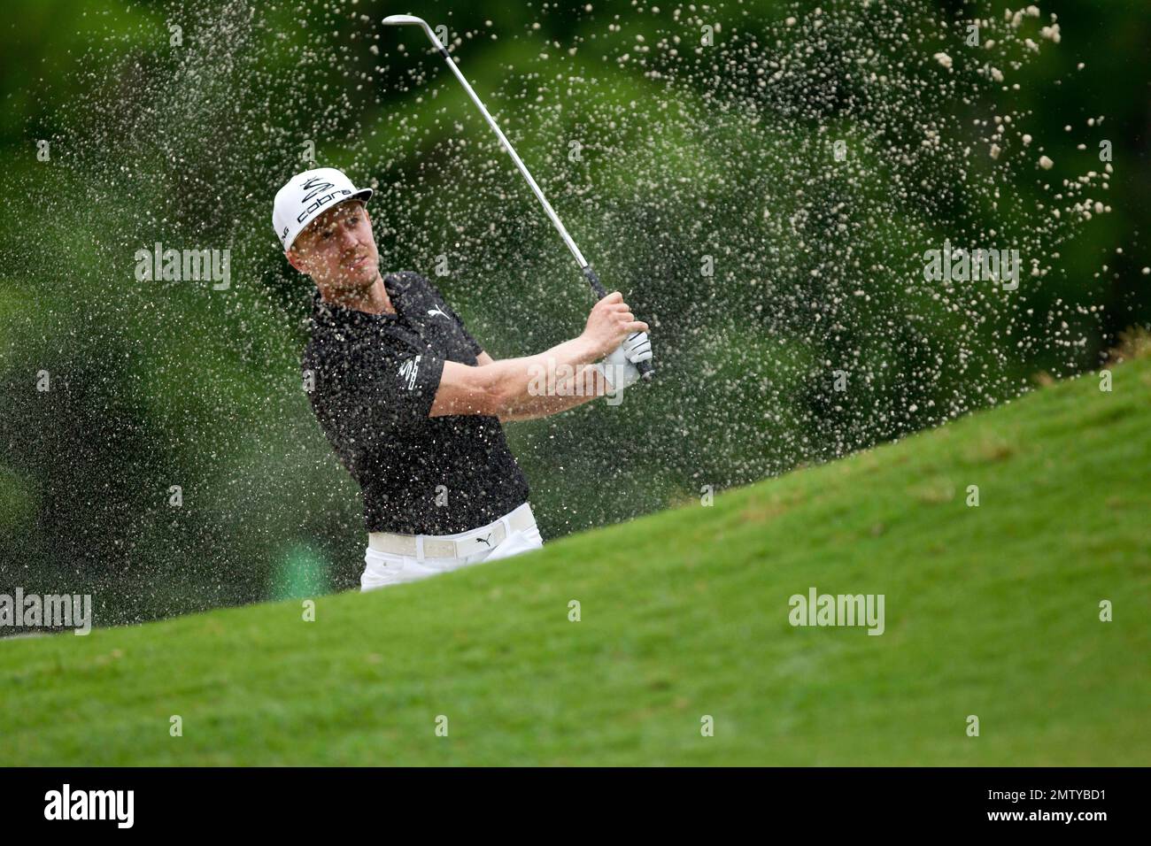 Jonas Blixt, of Sweden, hits out of sand trap on the second hole during ...