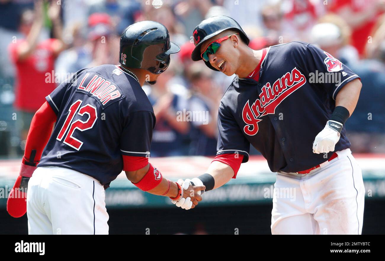 Cleveland Indians' Michael Brantley, right, gets congratulations from ...