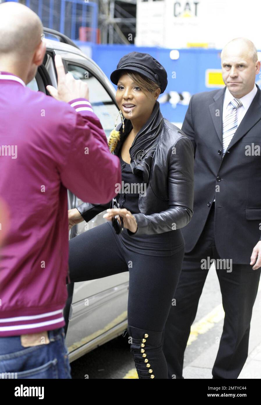 Singer Toni Braxton wears an all-black outfit of leggings, knee-high ...