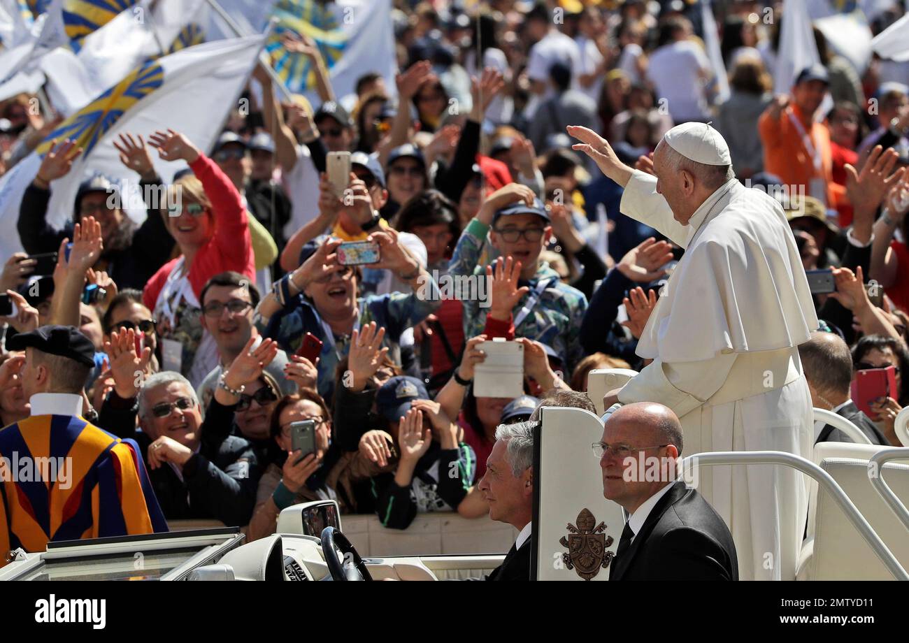 Pope Francis is driven through the crowd in St. Peter's Square at the ...