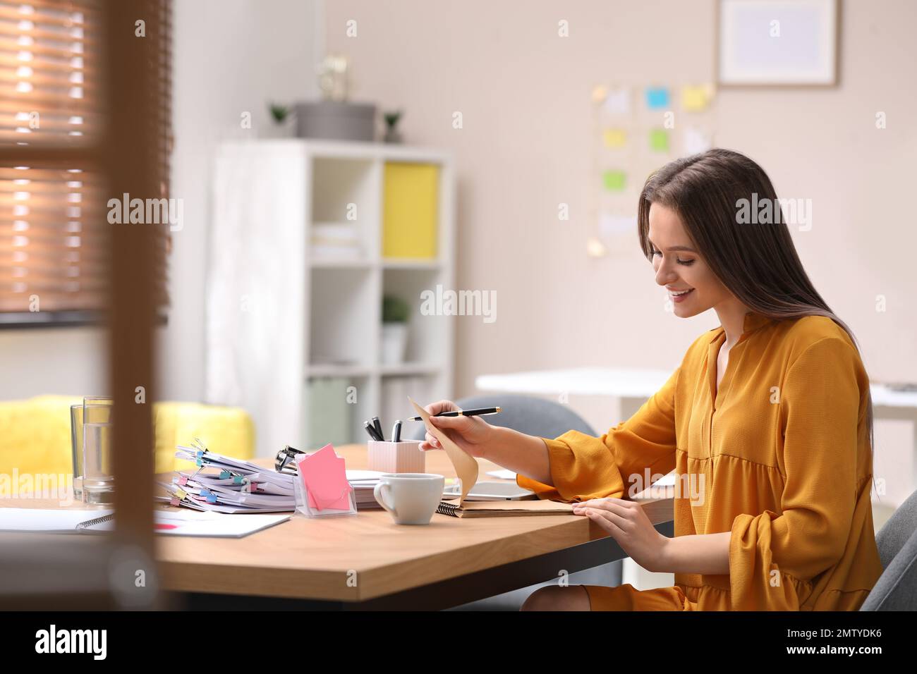 Young journalist at workplace in light office Stock Photo - Alamy