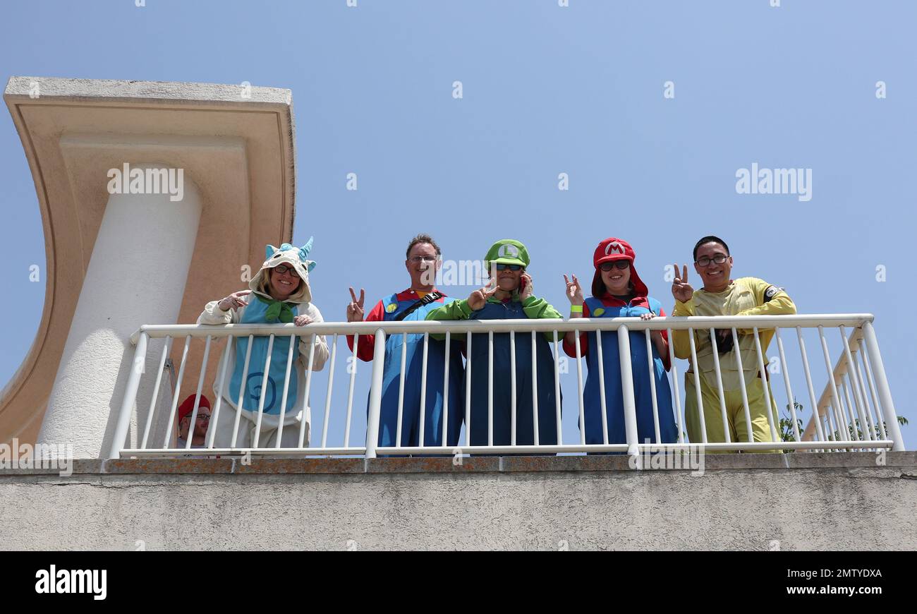 Foreign tourist pose by a costume of super Mario and other characters ...