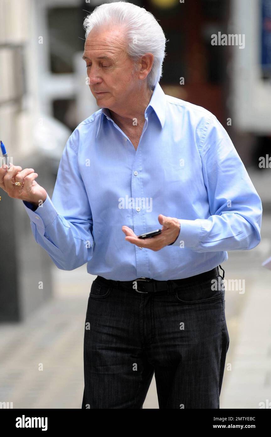 Singer Tony Christie is all smiles as he poses for photos while ...