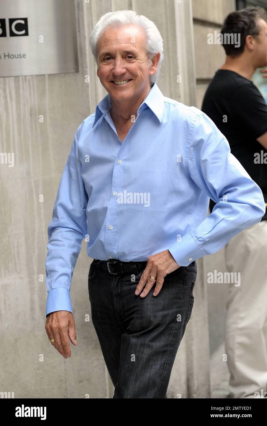 Singer Tony Christie is all smiles as he poses for photos while ...