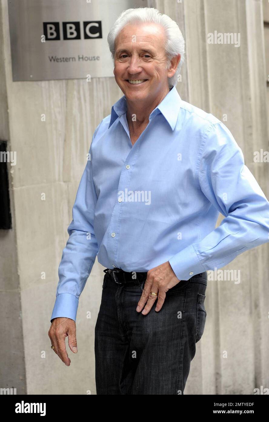 Singer Tony Christie is all smiles as he poses for photos while ...