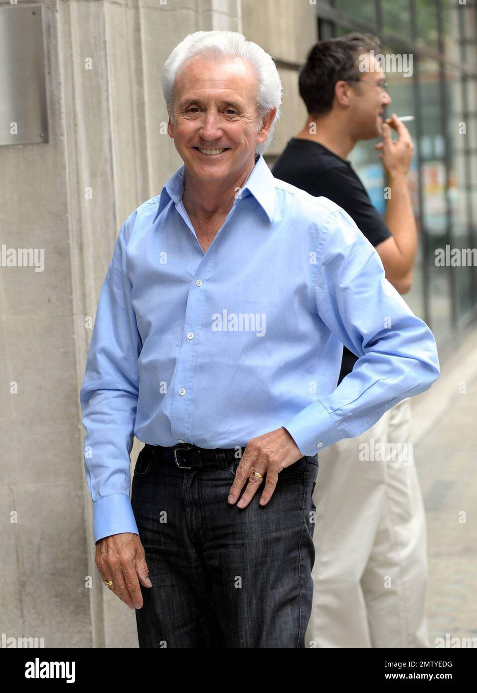 Singer Tony Christie is all smiles as he poses for photos while ...