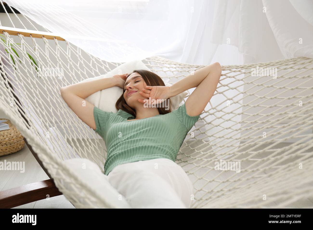Happy woman lying in hammock at home Stock Photo - Alamy