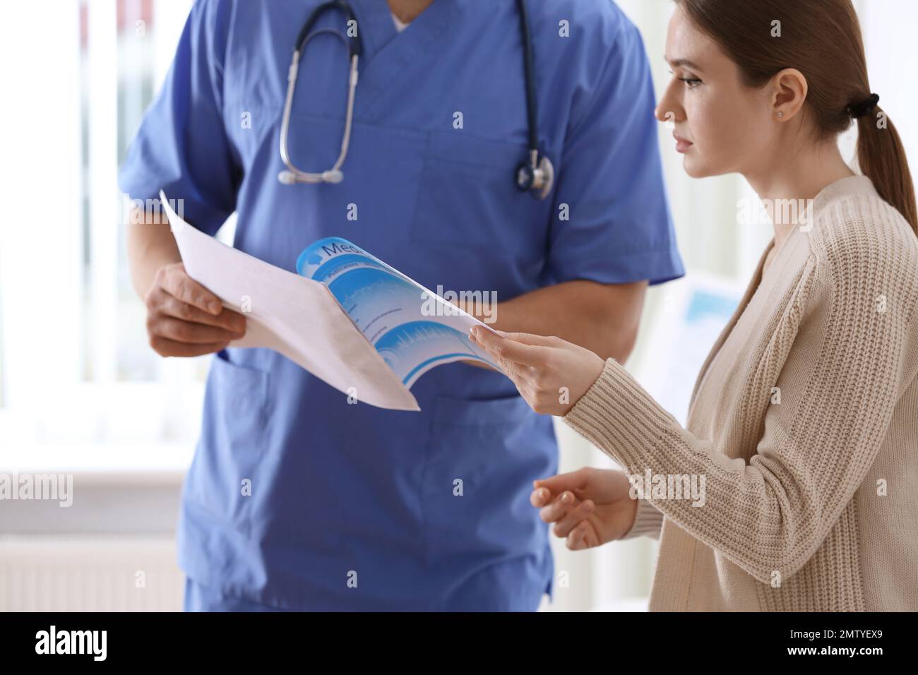 Doctor showing medical record to patient in clinic, closeup Stock Photo ...