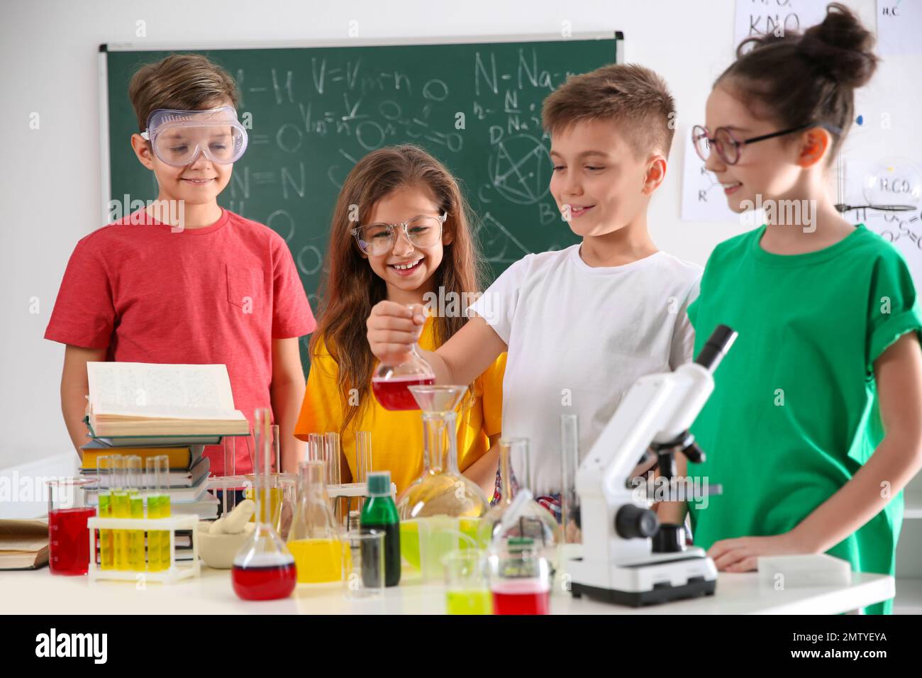 Smart pupils making experiment in chemistry class Stock Photo - Alamy