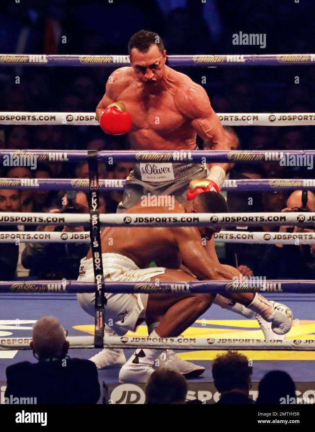 British boxer Anthony Joshua, front, is knocked down by Ukrainian boxer ...