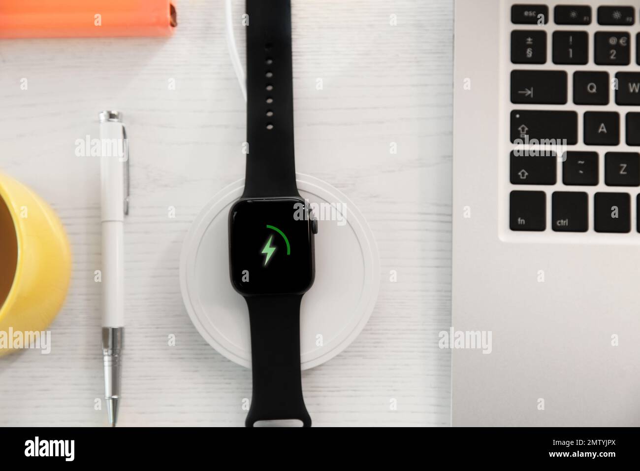 Flat lay composition with smartwatch and wireless charger on white ...