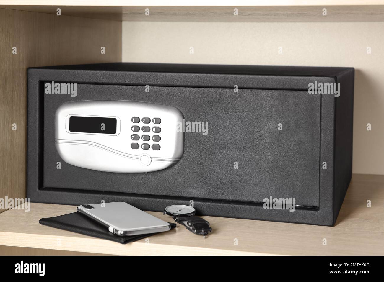 Black steel safe with electronic lock in wooden closet Stock Photo - Alamy