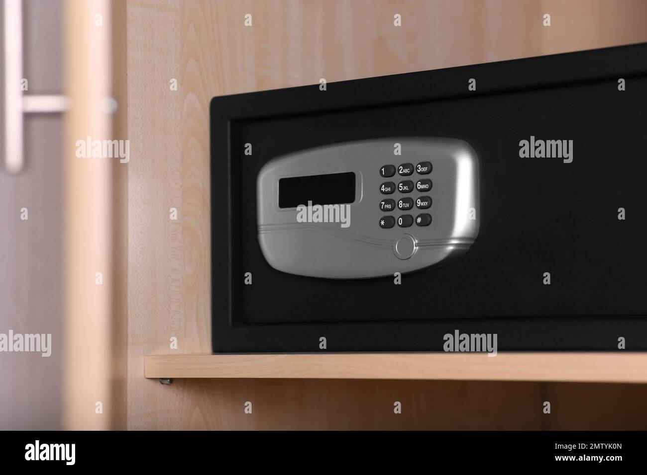 Black steel safe with electronic lock in wooden closet at hotel Stock ...