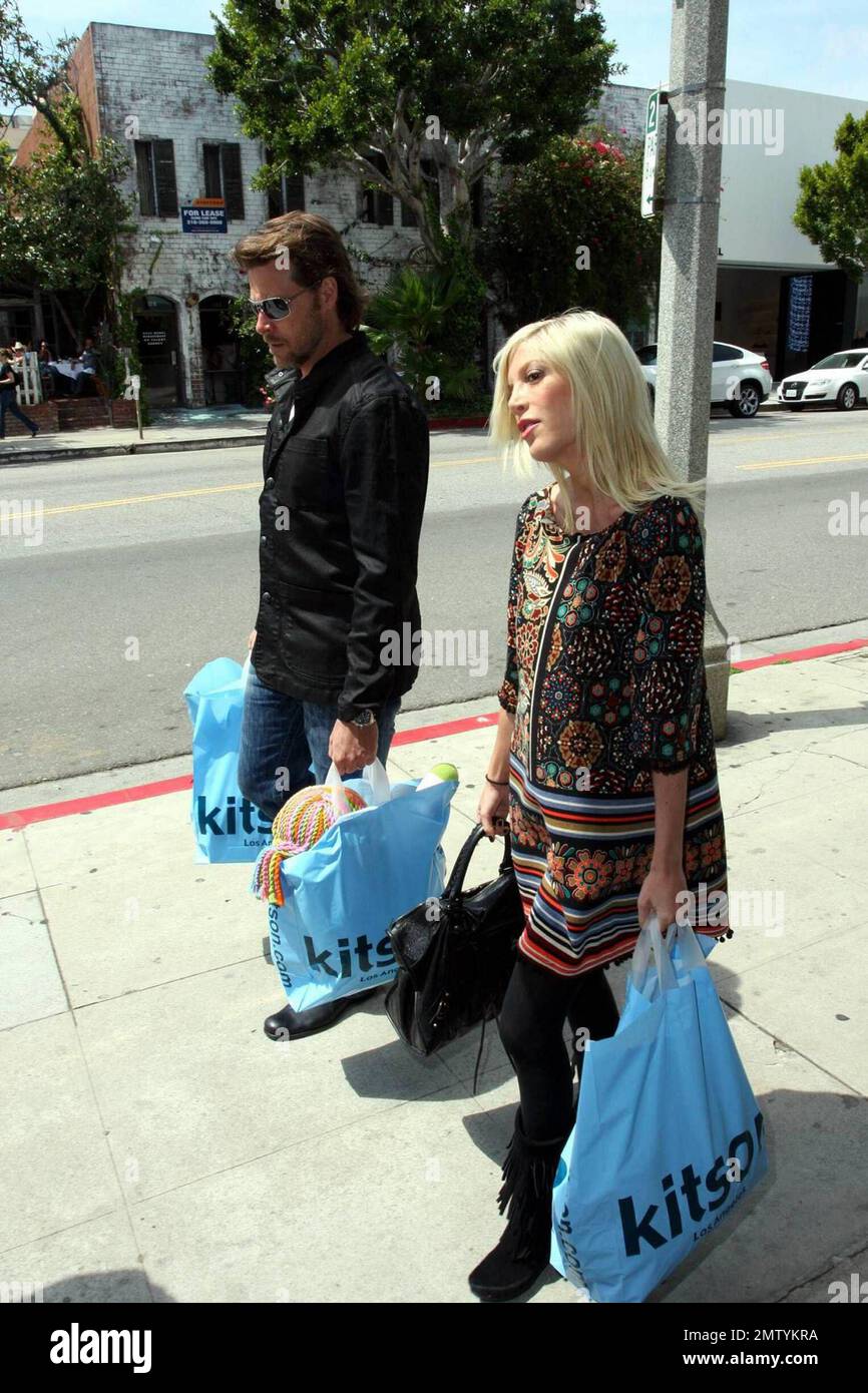 Tori Spelling wears a very busily patterned dress as she shops with ...