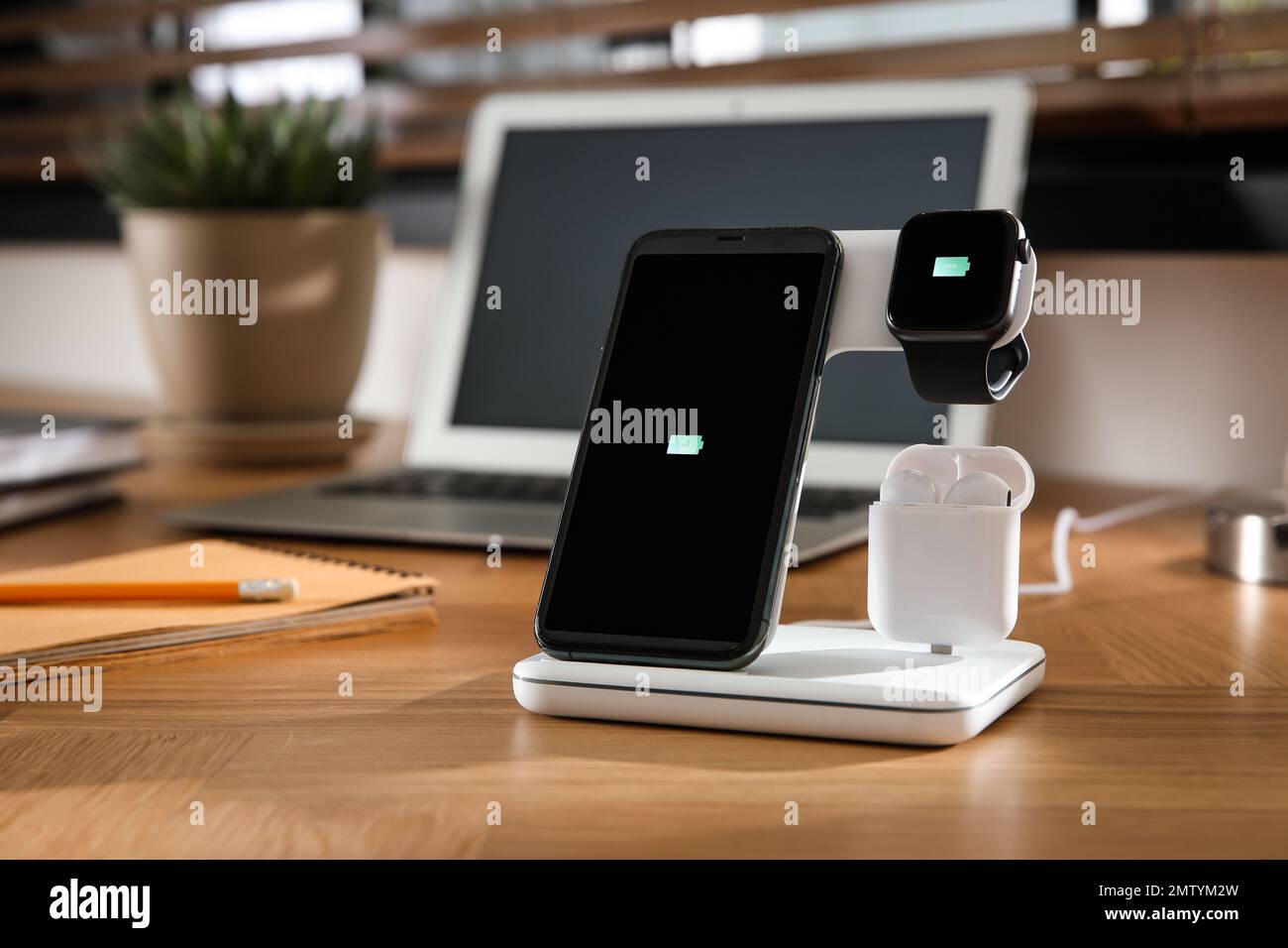 Mobile phone, earphones and smartwatch charging with wireless pad on ...