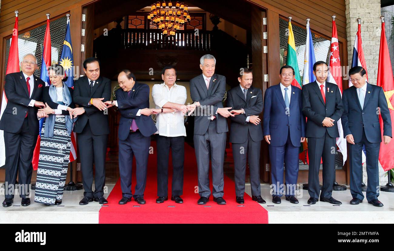 Southeast Asian leaders prepare to link arms as they pose for a family ...