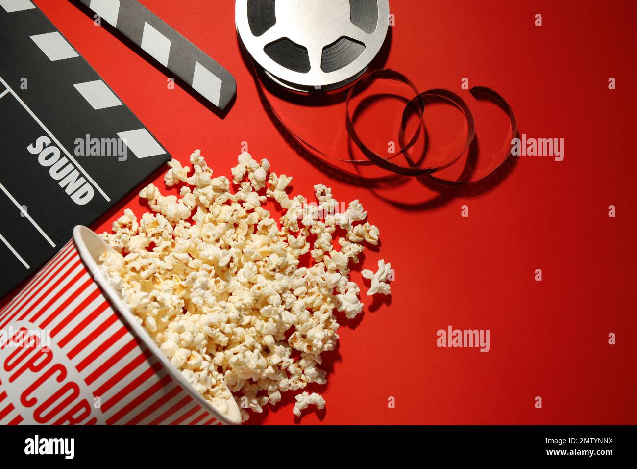 Flat lay composition with delicious popcorn on red background Stock ...