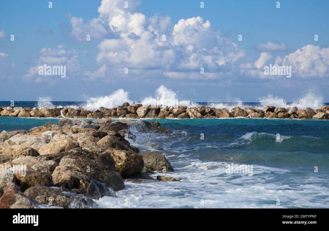 waves crash against the rocky shore. Beautiful sea landscape. Foamy sea ...