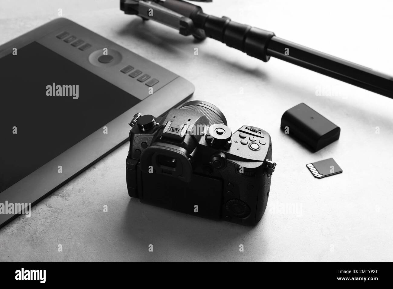 Modern camera on light grey stone table. Video production industry ...