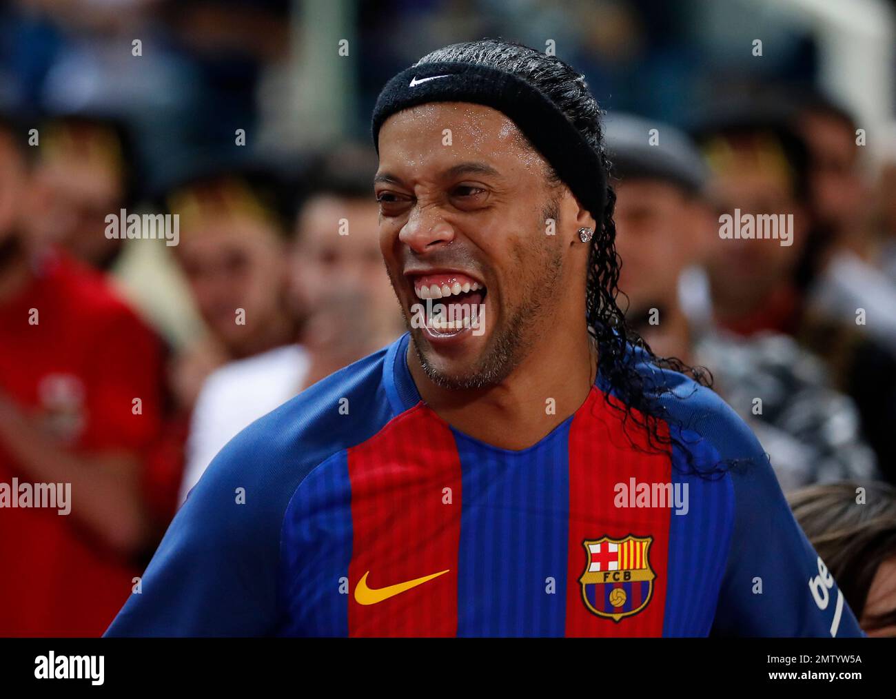 Former FC Barcelona player Ronaldinho, laughs as he enters the stadium ...